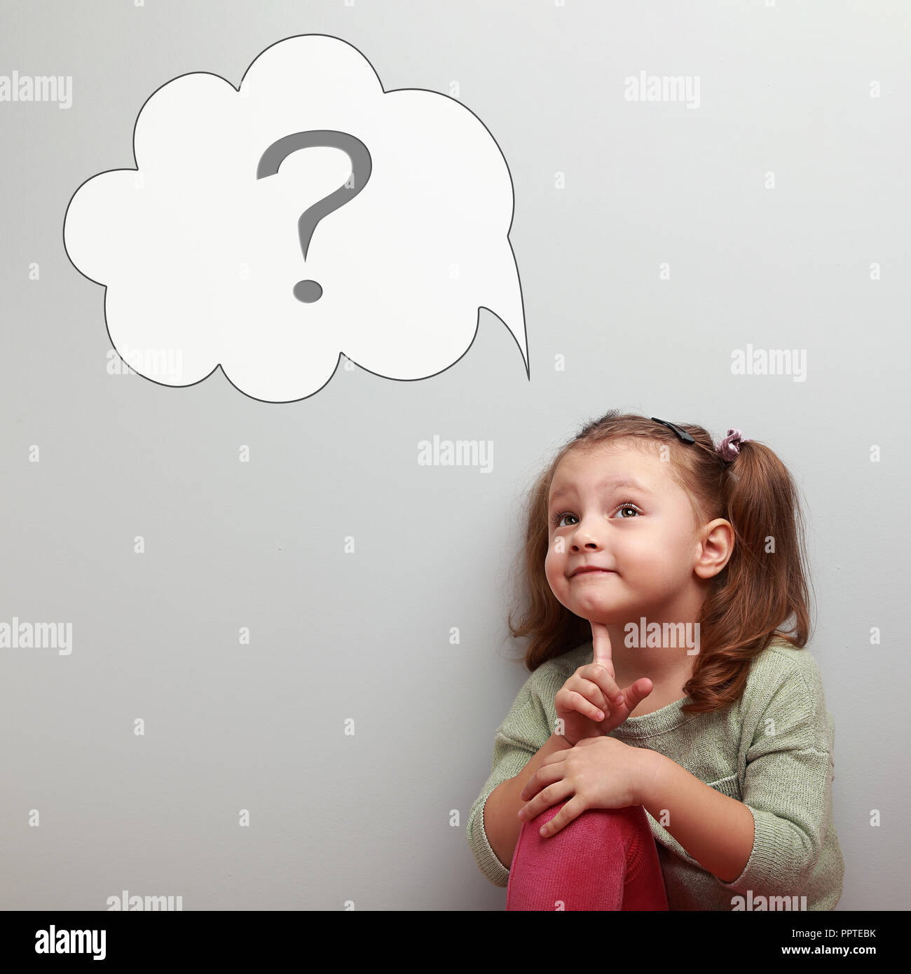 Fun thinking kid looking up on idea cloud bubble with question sign ...