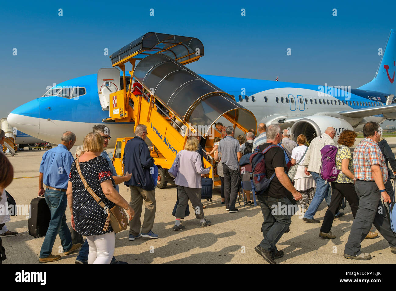 Passengers walking out to board their plane at Verona airport, Italy ...