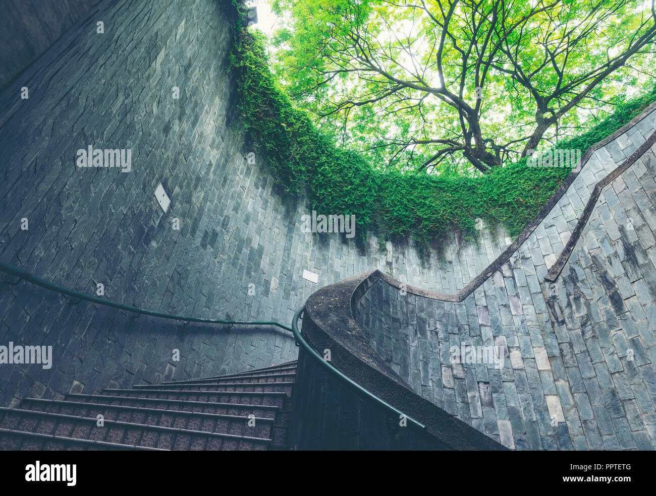 Travel in Singapore .Spiral staircase of underground crossing in tunnel ...