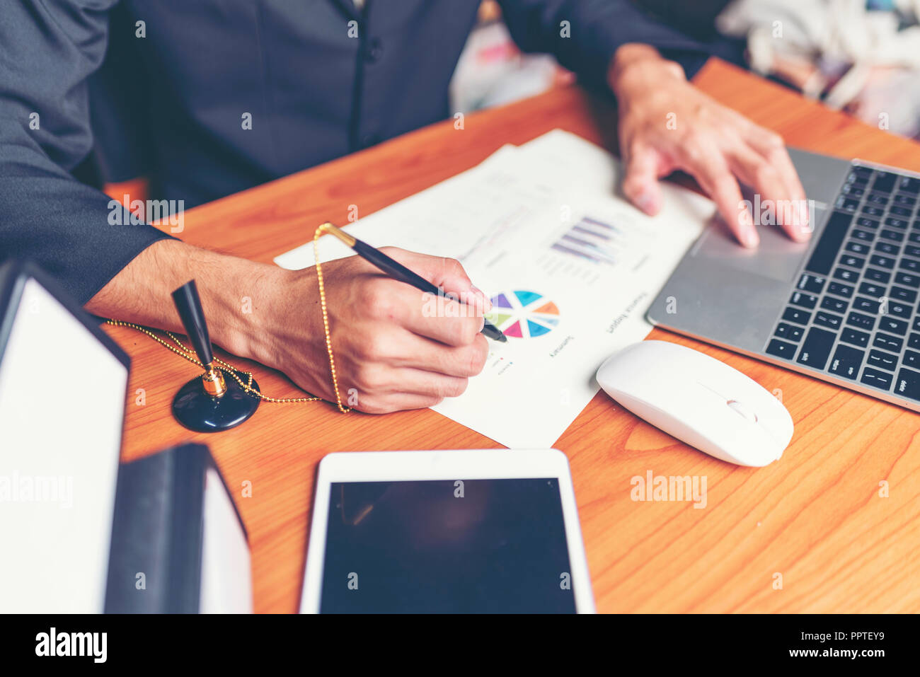 Close up hands signing terms of agreement documents of businessman on ...