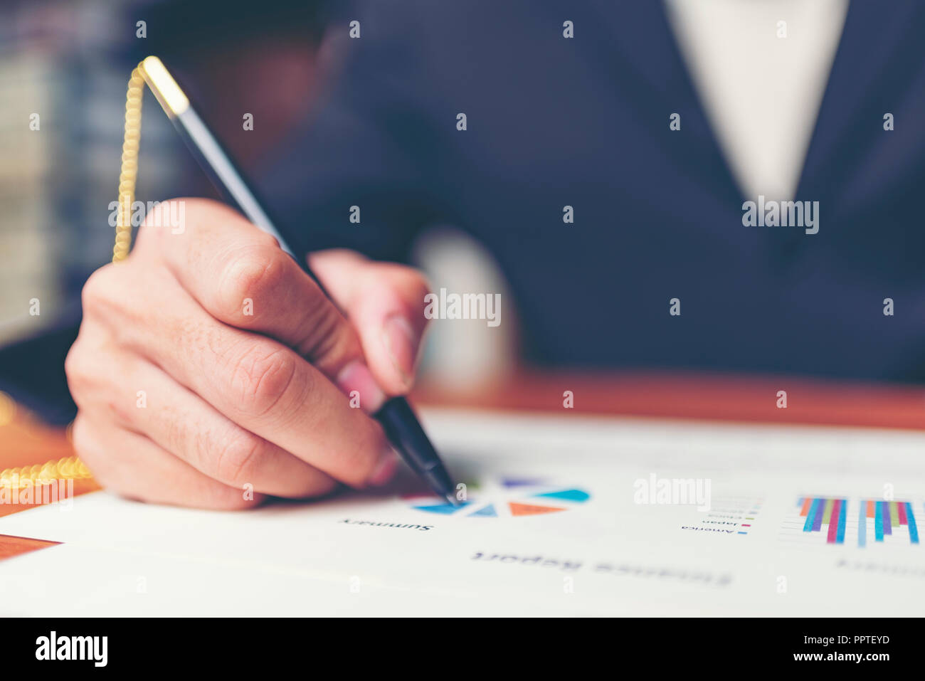 Close up hands signing terms of agreement documents of businessman on ...
