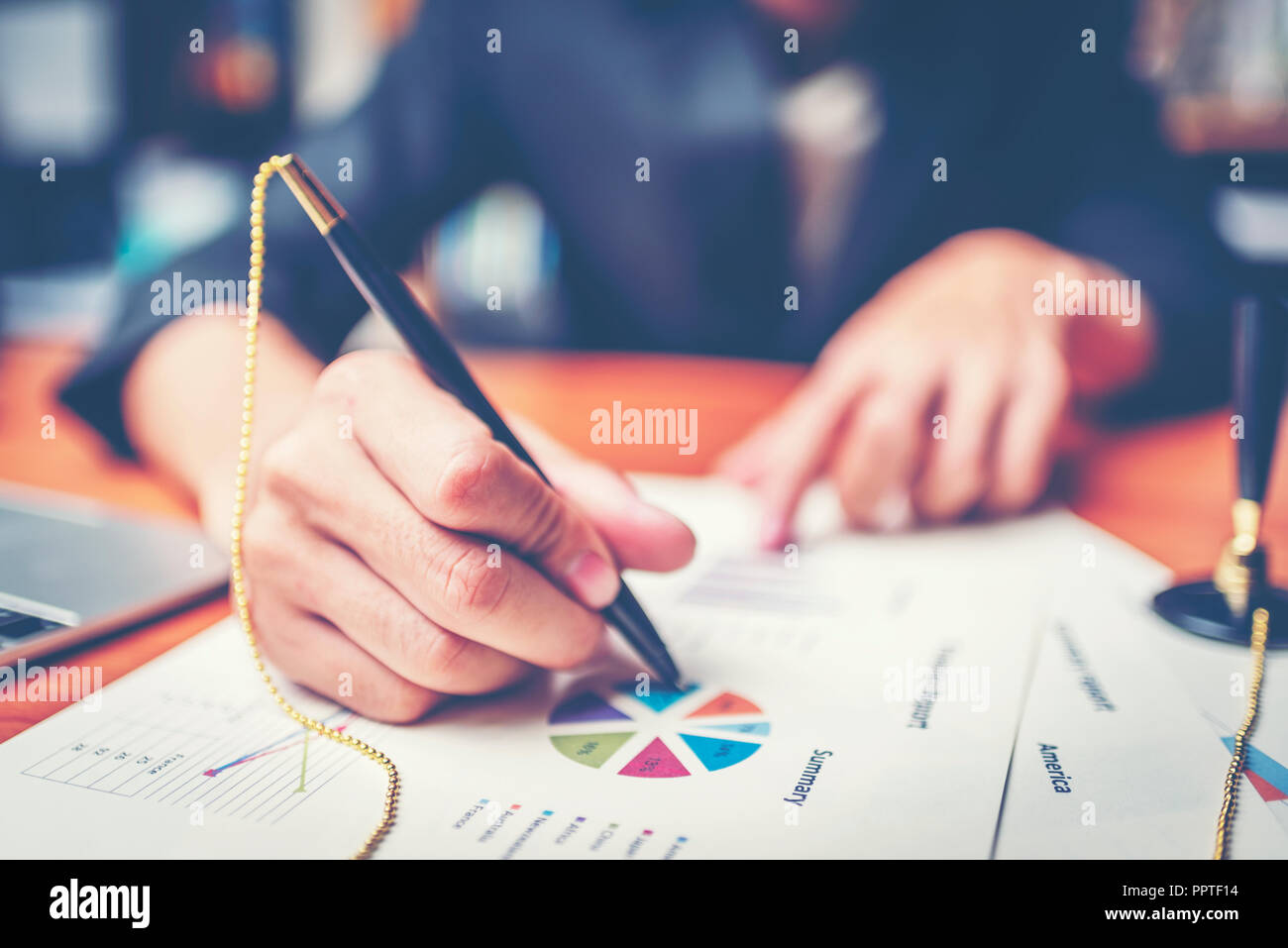 Business hands pointing and signing terms and agreement papers contract ...