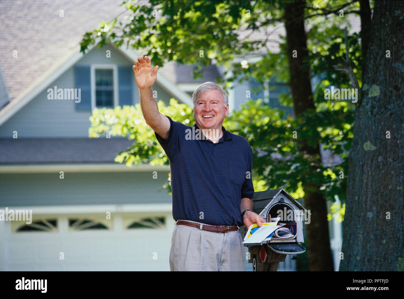 Mature Home owner collecting Mail at private mailbox,USA Stock Photo ...