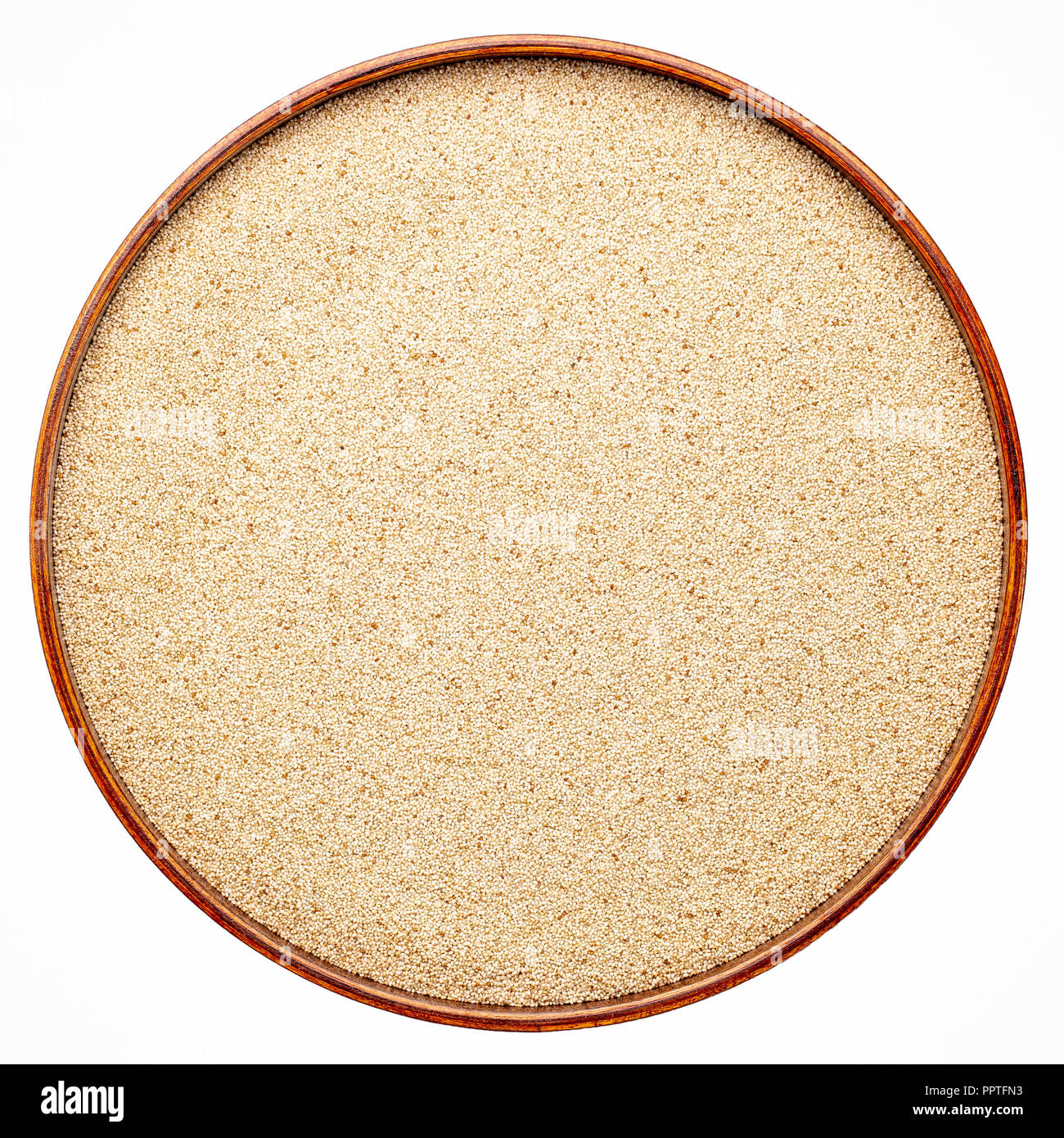 gluten free ivory teff grain in a round wooden tray isolated on white ...
