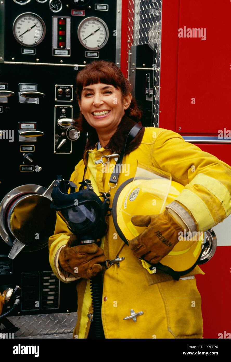 Female Hispanic Firefighter Poses in front of a Fire Truck, California ...