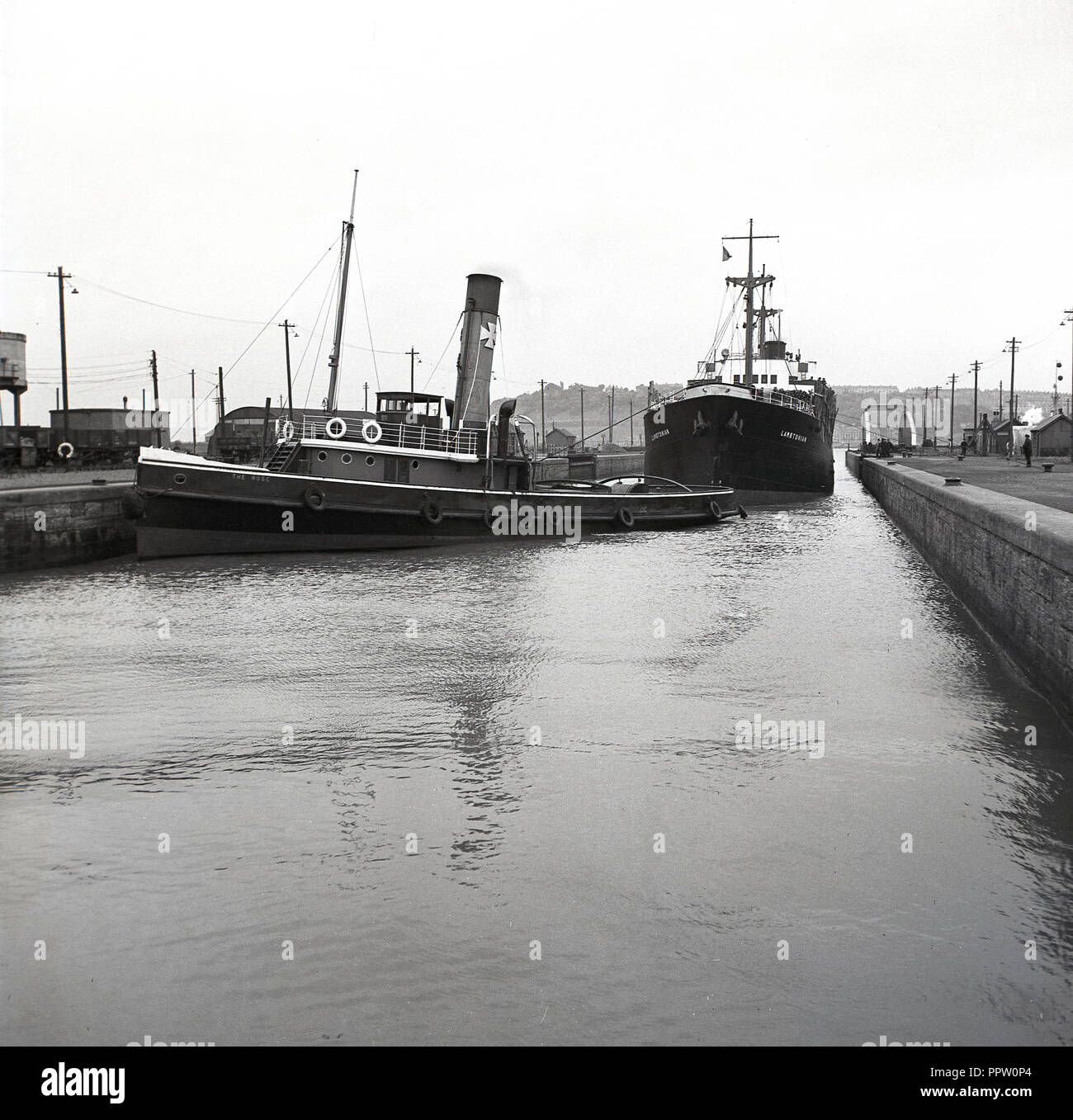 1950s, historical, steam-drived tugboat, 'The Rose', pulling in a large ...