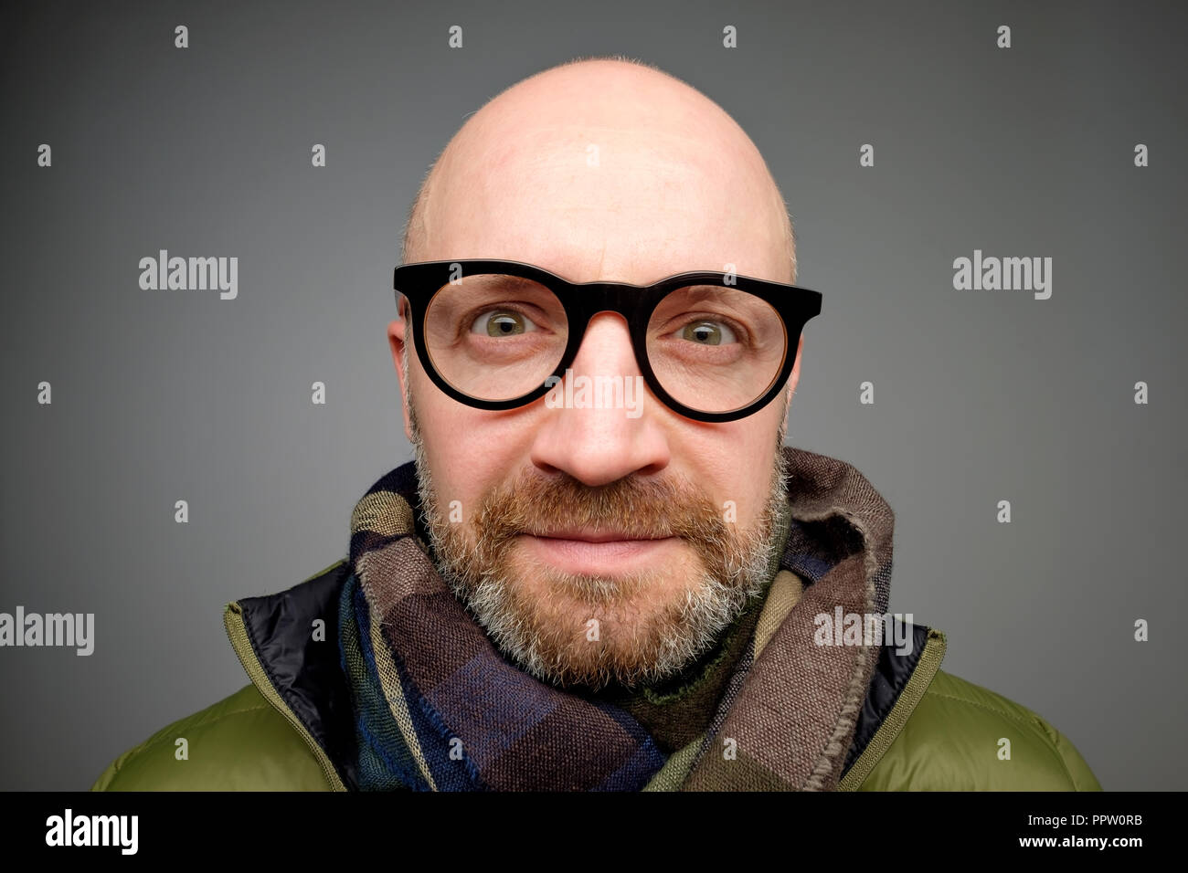 Cheerful guy smiles happily. Confident bald man with glasses wearing ...