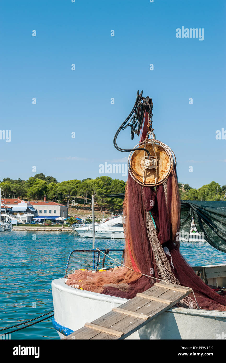 fishing nets raises the crane on the pier by the sea. Fish products ...