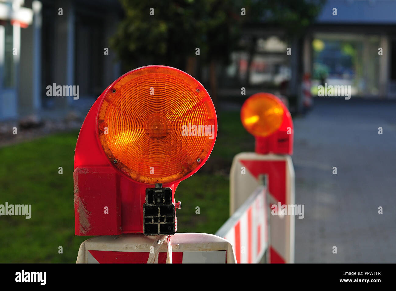 yellow reflector of a signal light at red white plastic boundary for ...