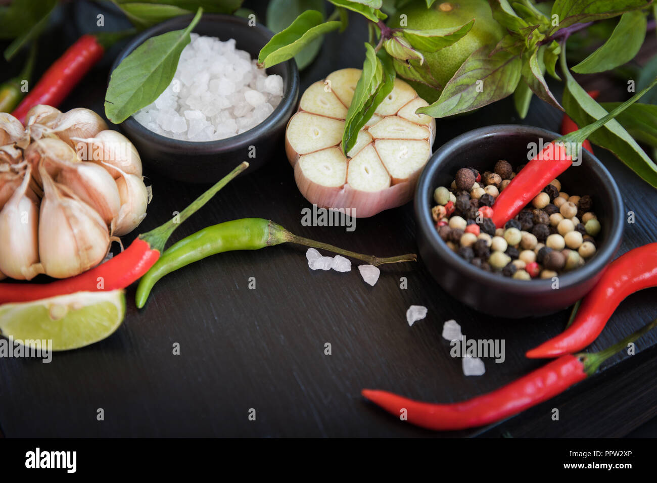 Different types of spices and herbs for cooking on black slate ...