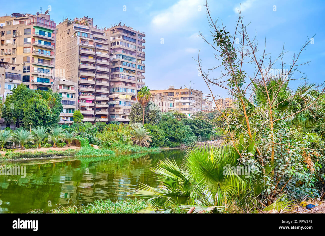 The banks of Nile River are planted with lush greenery, that makes ...