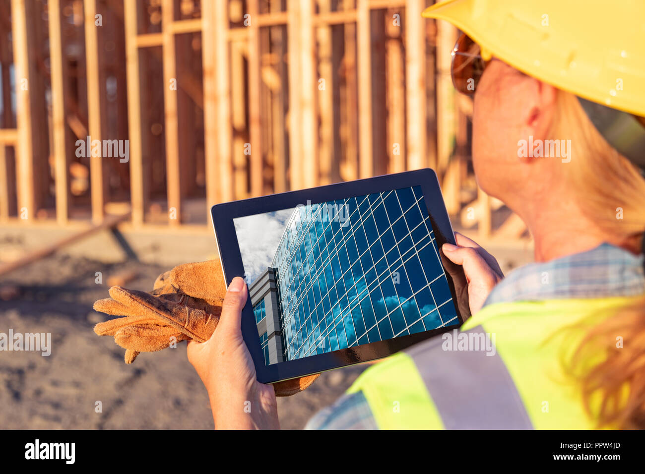 Female Construction Workers Reviewing Building on Computer Pad at ...