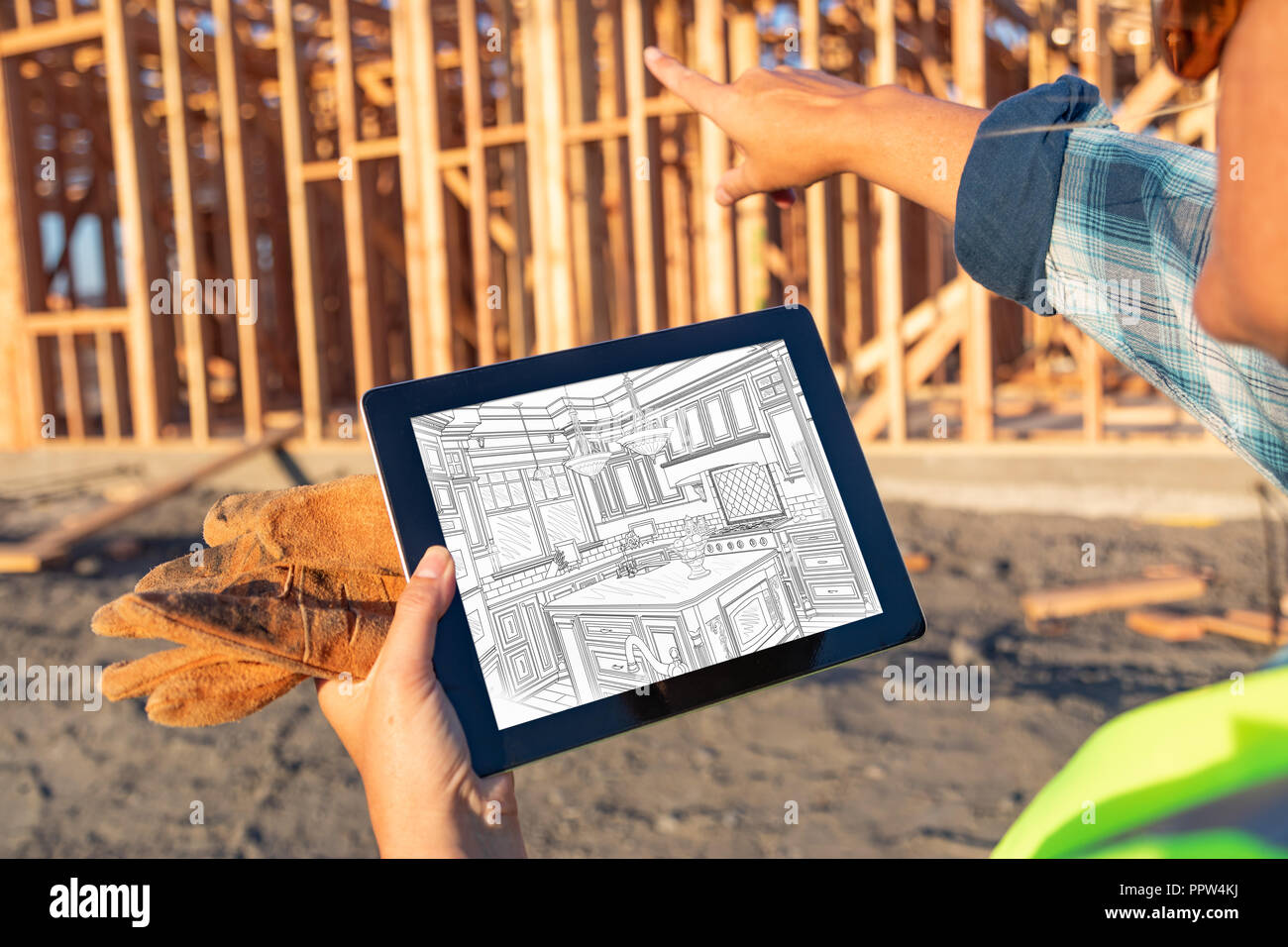 Female Construction Worker Reviewing Kitchen Drawing on Computer Pad at ...