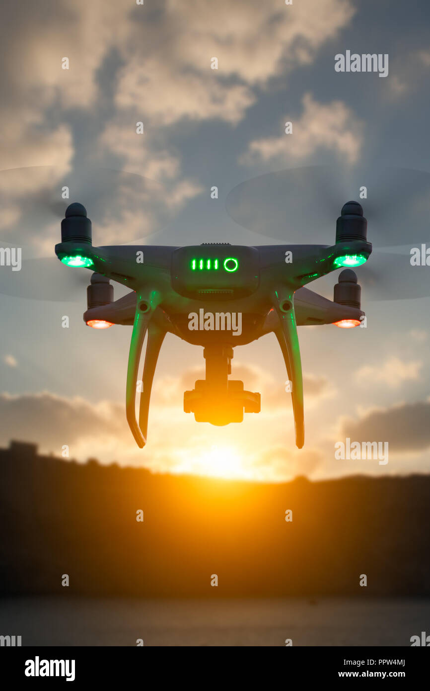 Silhouette of Unmanned Aircraft System (UAV) Quadcopter Drone In The ...