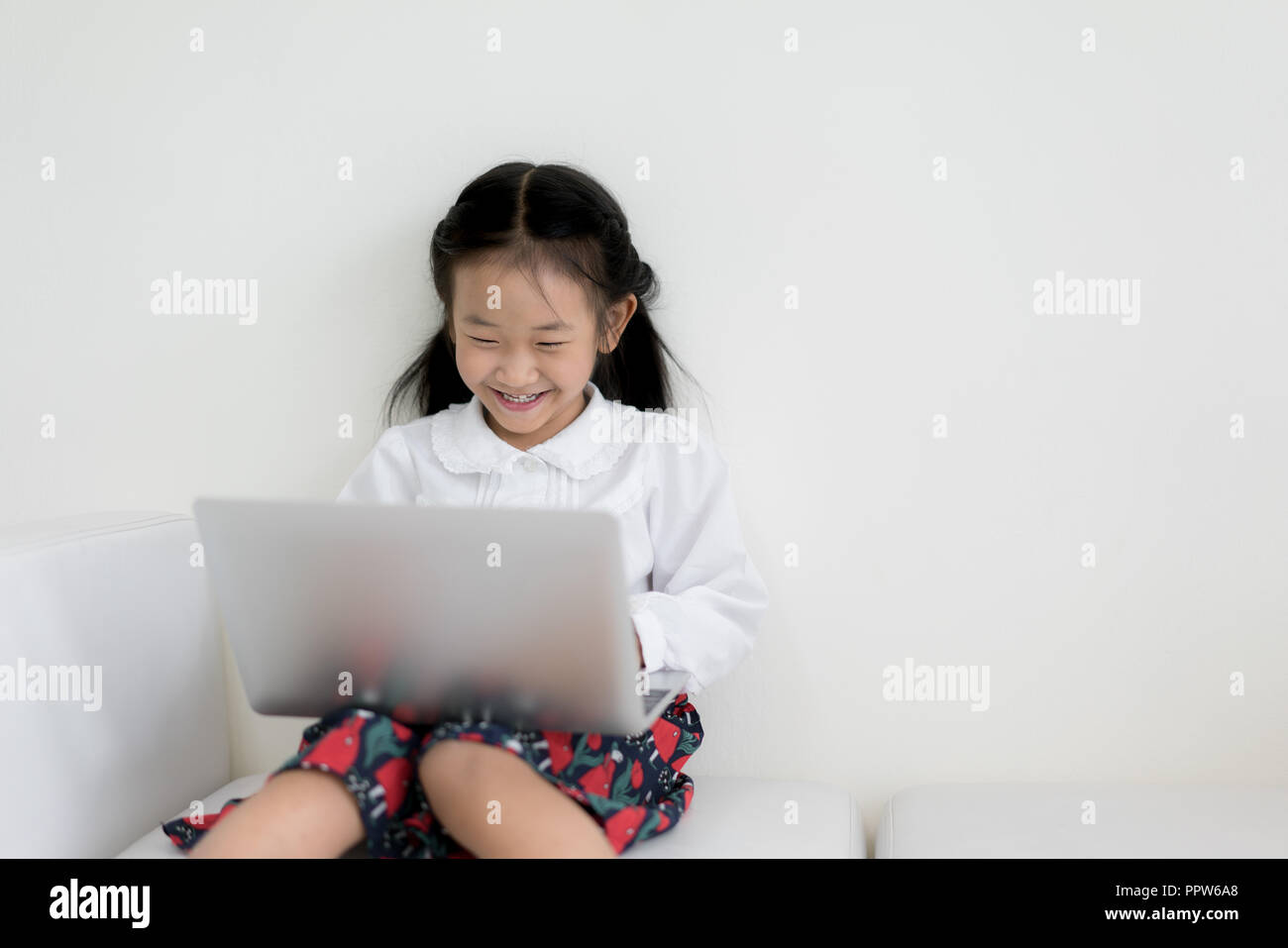 Little girl using computer hi-res stock photography and images - Alamy