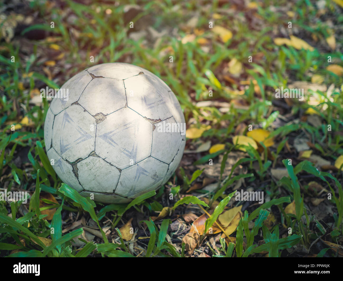 Dirty soccer ball on grass hi-res stock photography and images - Alamy