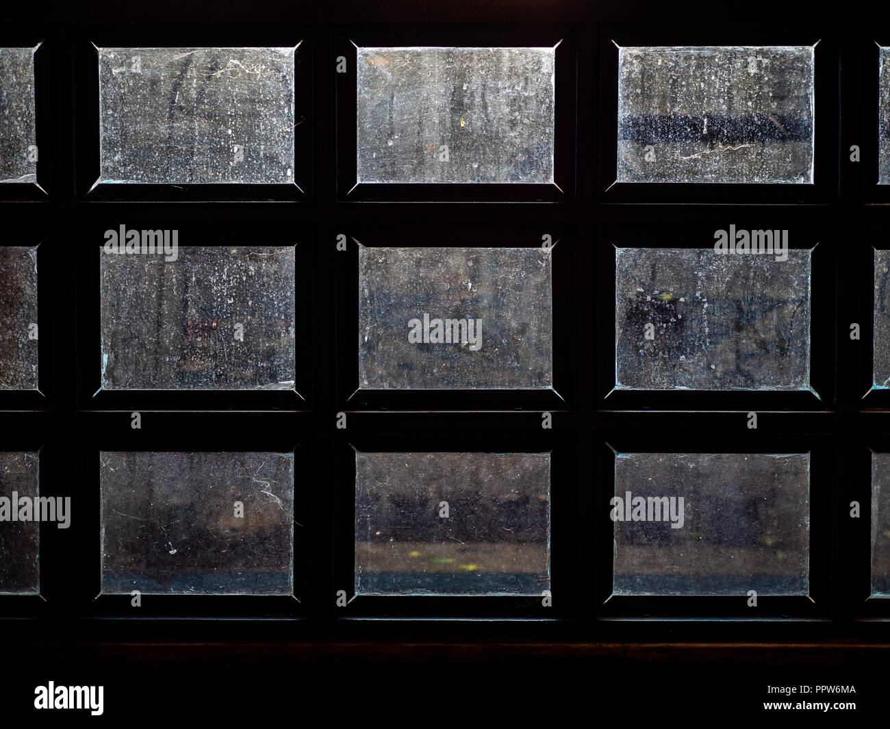 Dirty window glass with the light from outside. Water stain on the ...