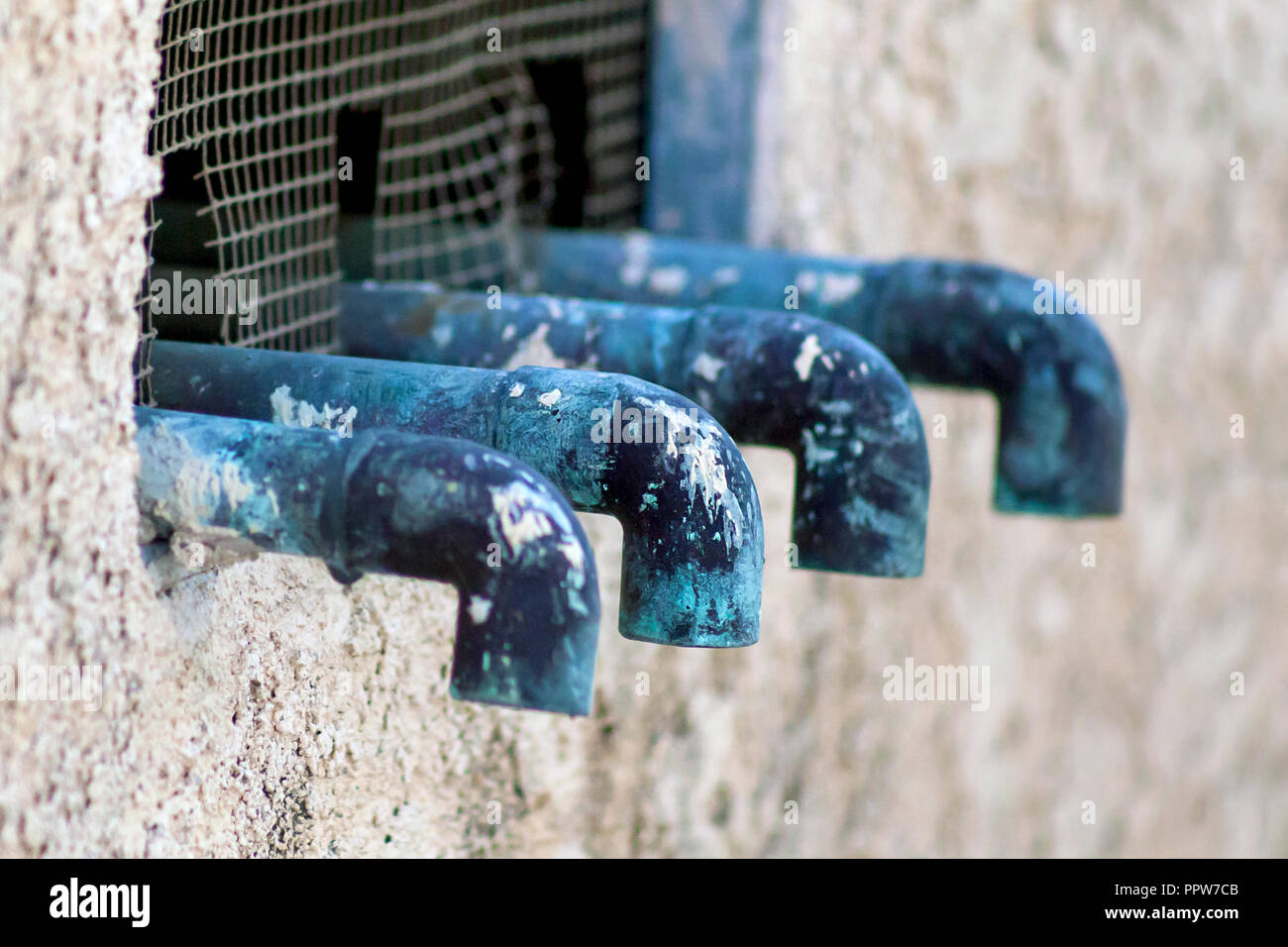 Water Pipes with textured wall and old net Stock Photo - Alamy
