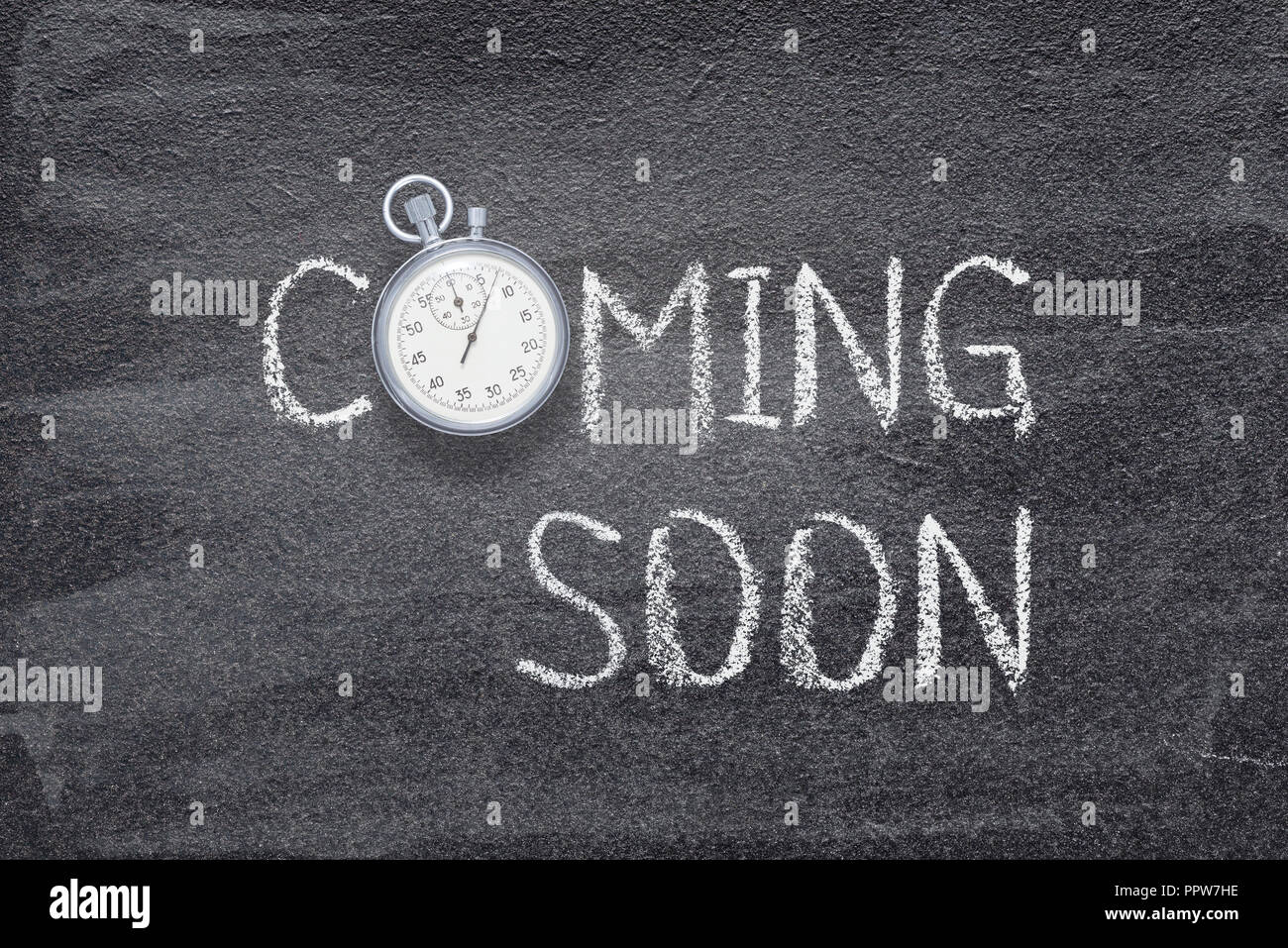 coming soon phrase written on chalkboard with vintage stopwatch used ...
