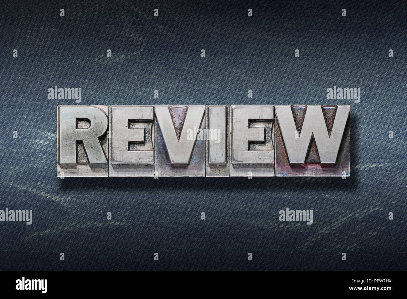 review word made from metallic letterpress on dark jeans background ...