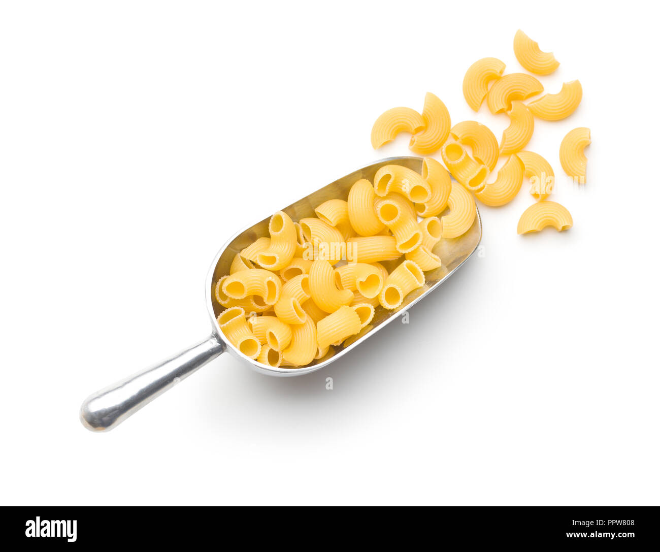 Uncooked elbow macaroni in scoop isolated on white background Stock ...