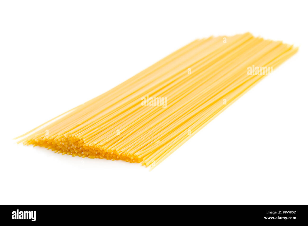 Uncooked spaghetti pasta isolated on white background Stock Photo - Alamy