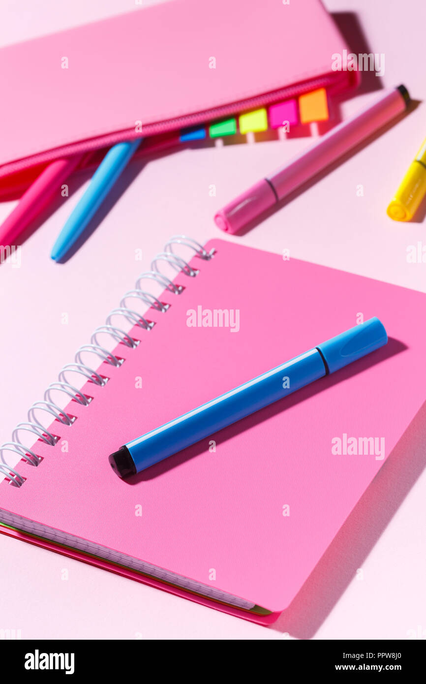 Pink notebook with marker on the background of the pencil case. Color ...