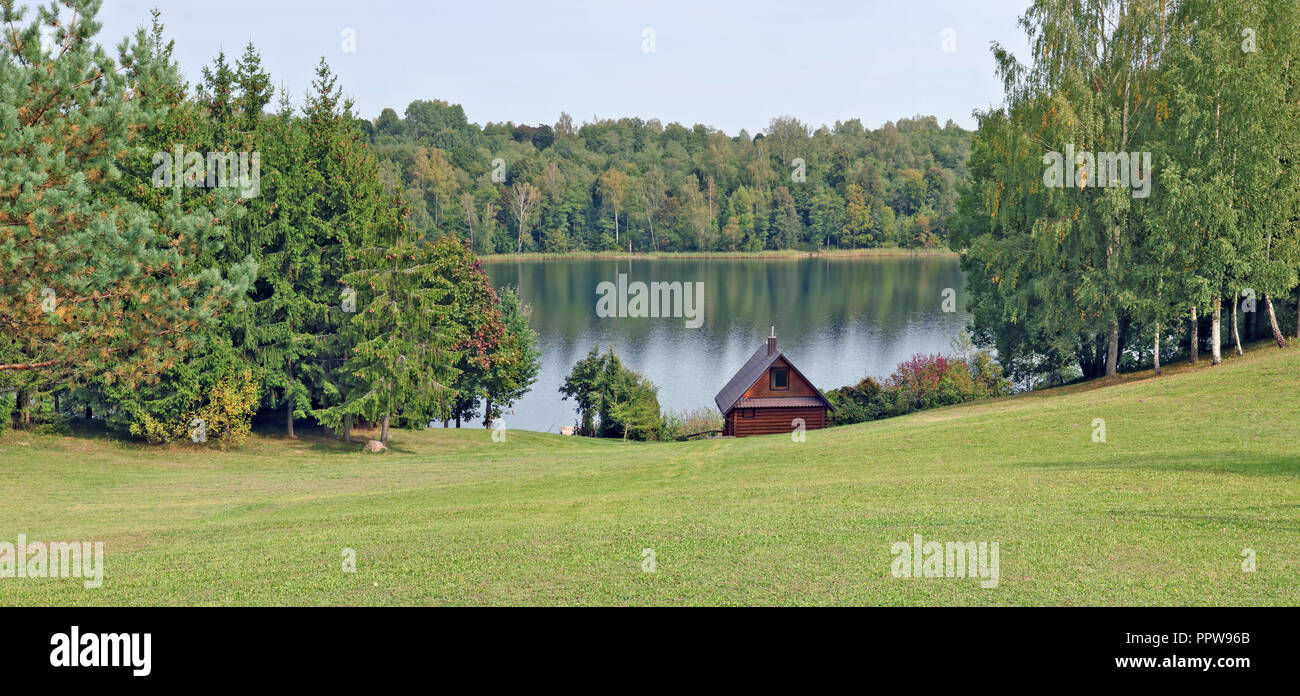 A typical rural Lithuanian landscape is a grassy hill on which a forest ...