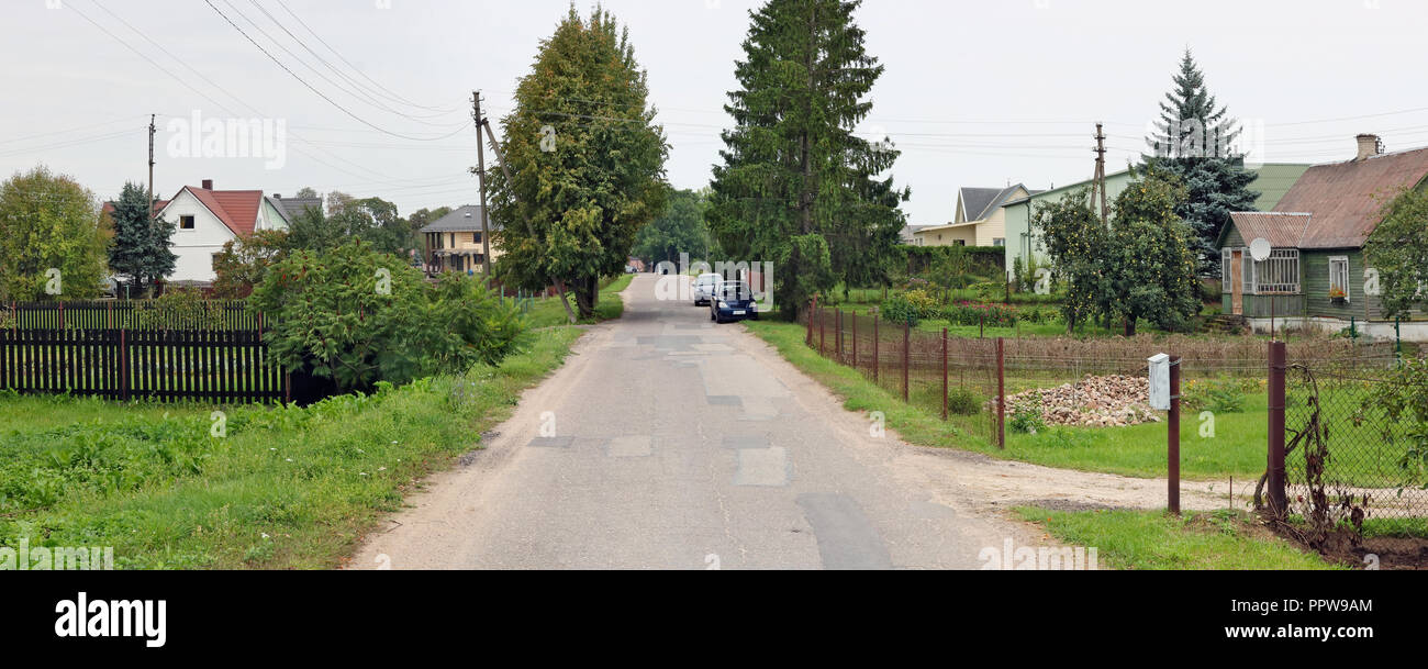 Broken asphalt road to a poor Lithuanian village rural landscape ...