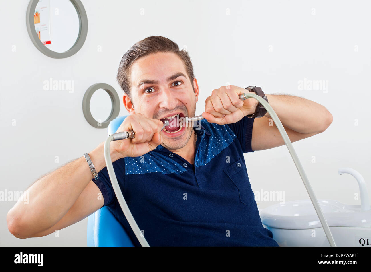 Crazy patient sitting in a dental chair Stock Photo - Alamy