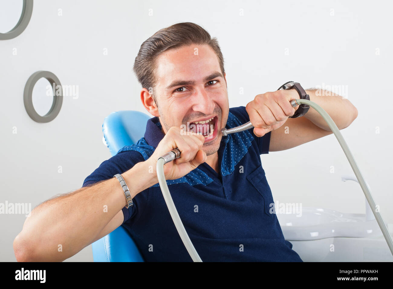 Crazy patient sitting in a dental chair Stock Photo - Alamy