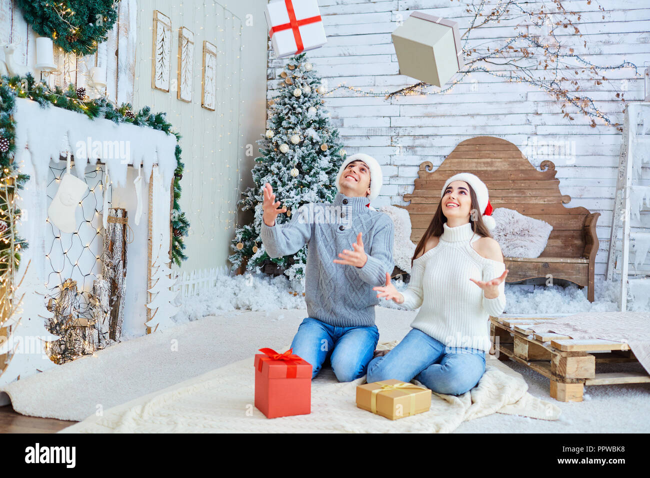 Happy young couple having fun at Christmas Stock Photo - Alamy