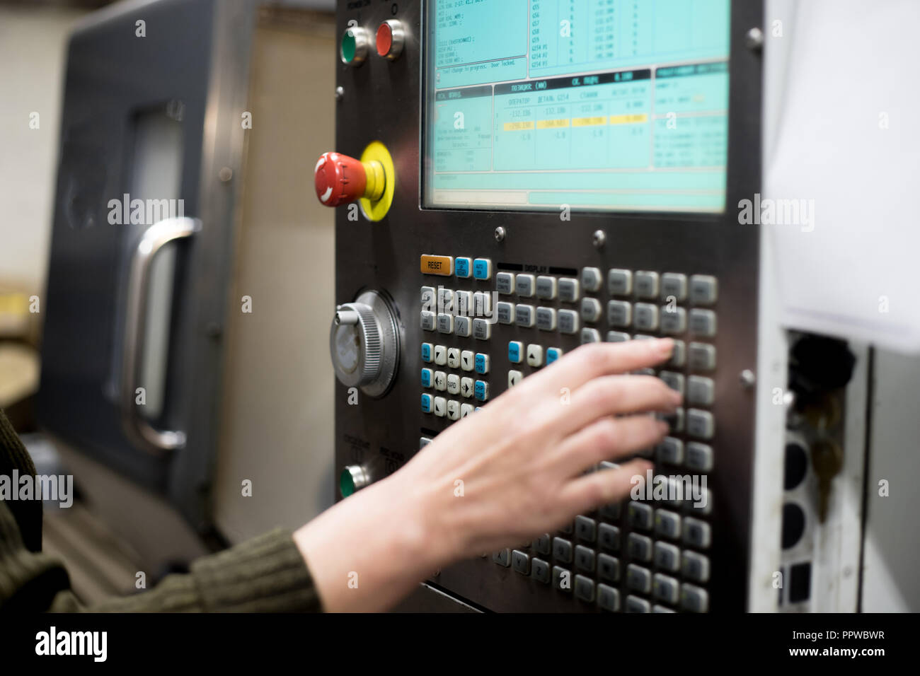 The hand enters data on the control panel of the lathe Stock Photo - Alamy