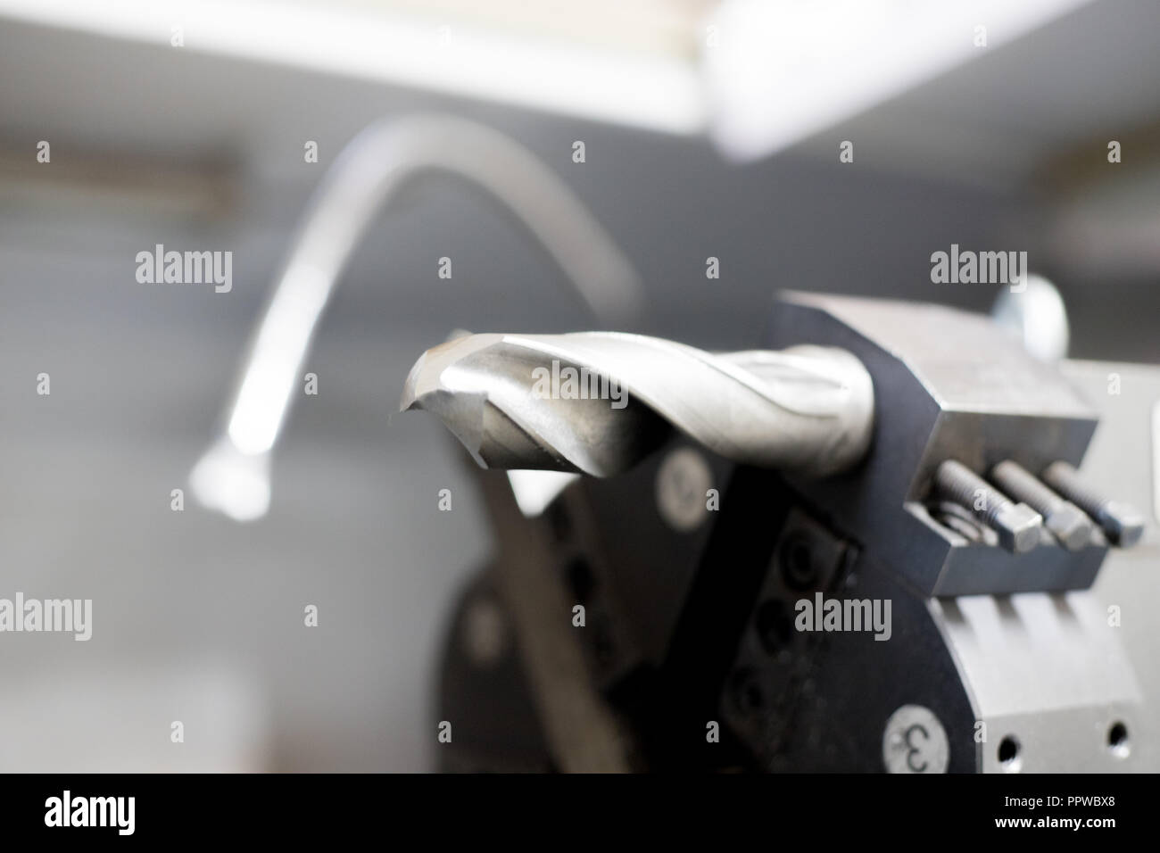 Shiny metal drill of lathe in the factory. Close up Stock Photo - Alamy