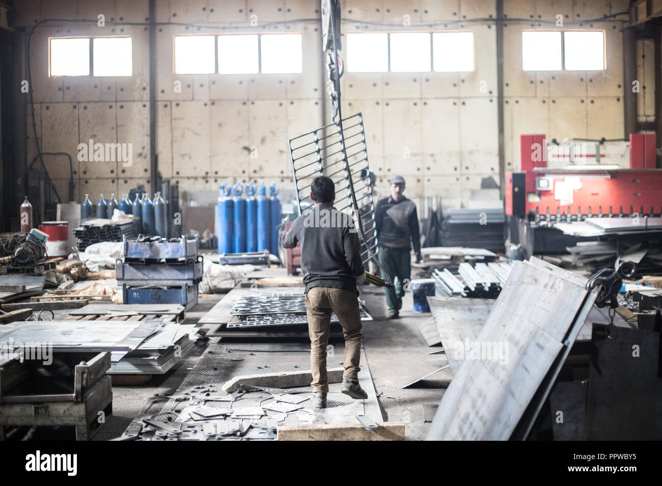 Workers in boots walk inside the industrial factory Stock Photo - Alamy