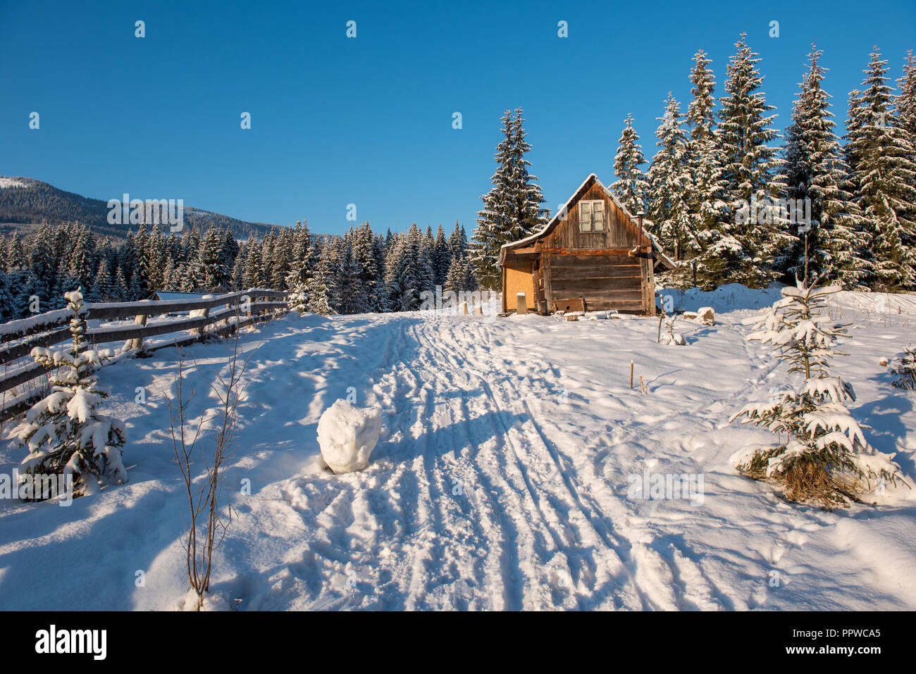 Idyllic winter wonderland mountain scenery with mountain chalet, lodge ...