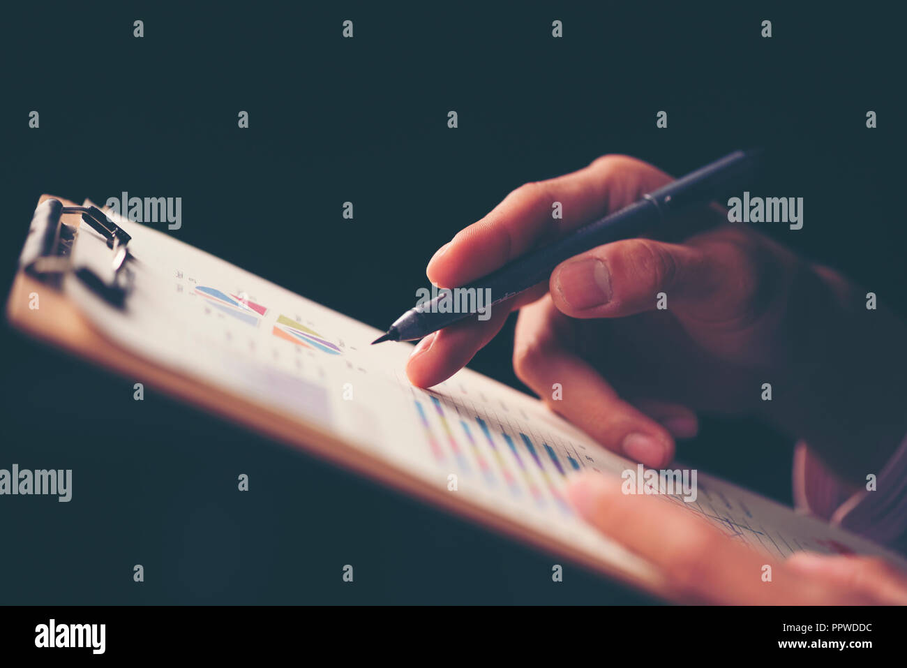 signing paperwork isolated on black Stock Photo - Alamy