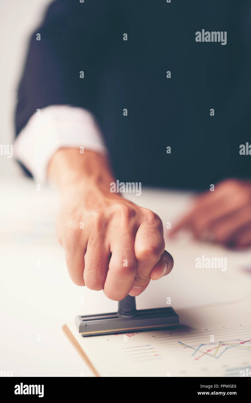 Close-up Of A Person's Hand Stamping With Approved Stamp On Document At ...