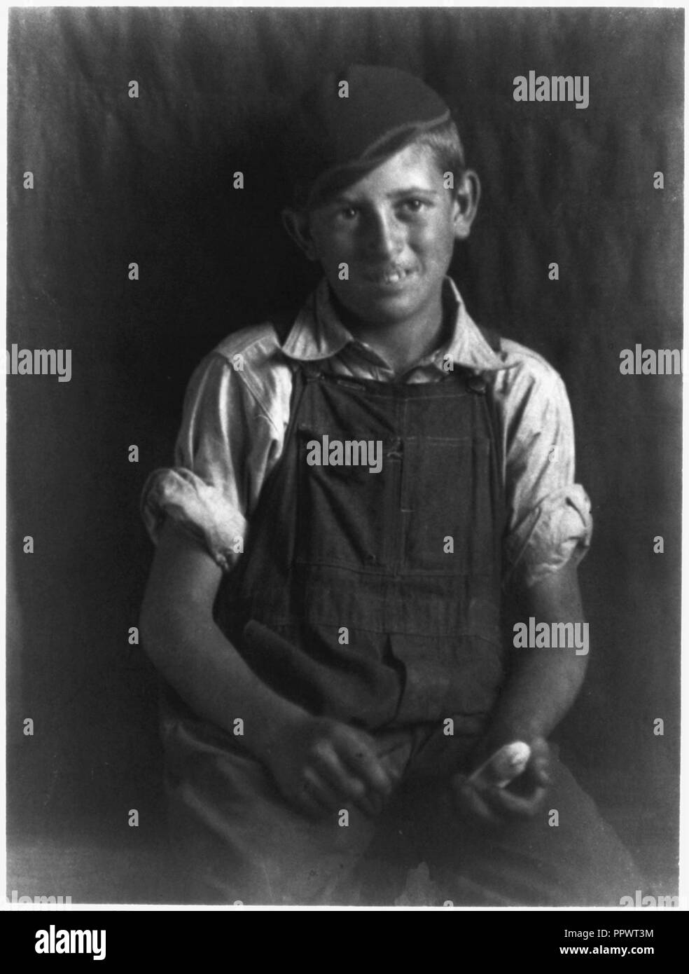 Boy in overalls and cap, photograph Stock Photo - Alamy