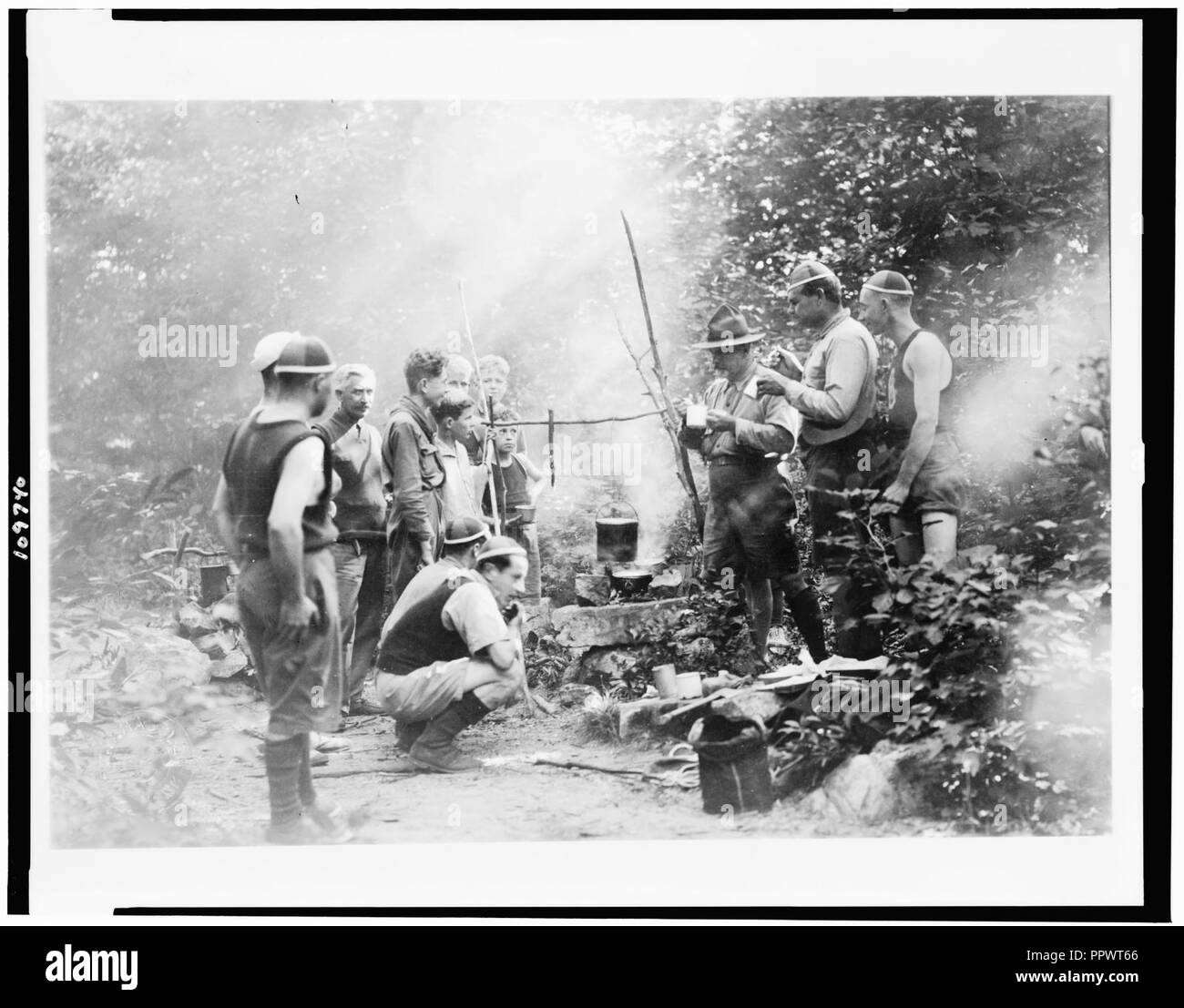 Boy Scouts cooking over open fire at Camp Ranachqua Stock Photo - Alamy