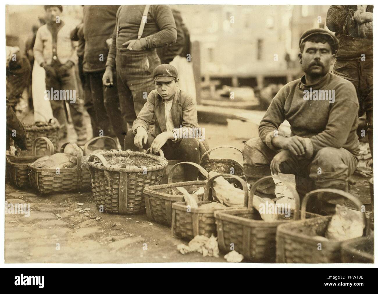 Boy selling fish in market Stock Photo - Alamy