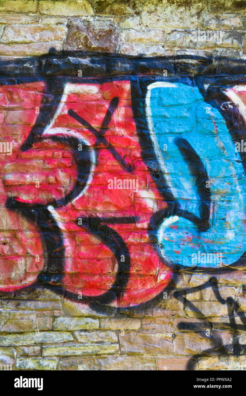 Painted graffiti on a stone brick wall Stock Photo - Alamy