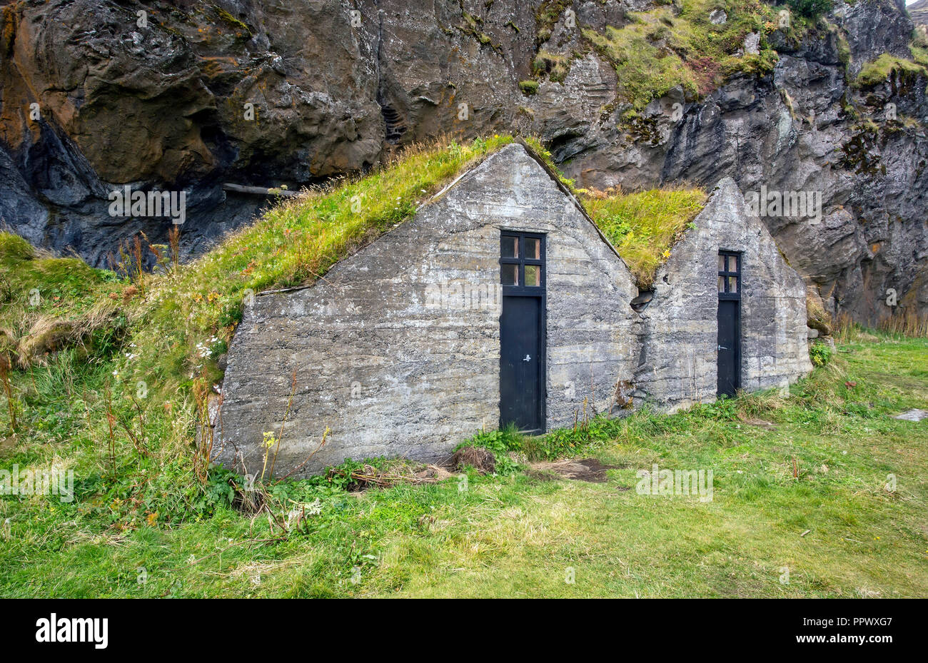 Two old turf-roofed houses near a rock cliff in Iceland Stock Photo - Alamy