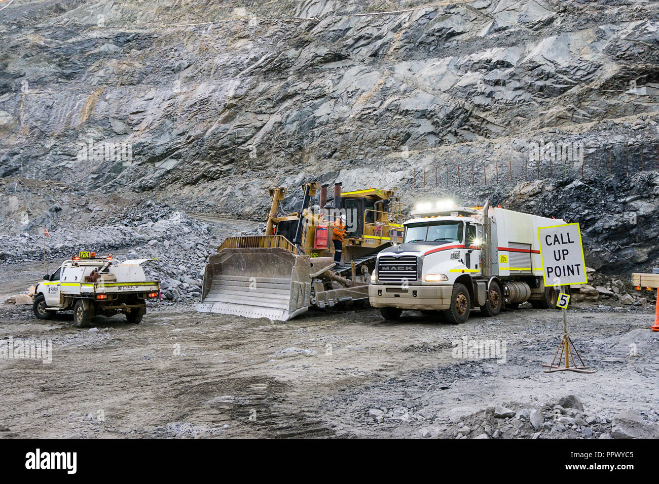 Heavy earth moving equipment on floor of open pit mine in Western ...