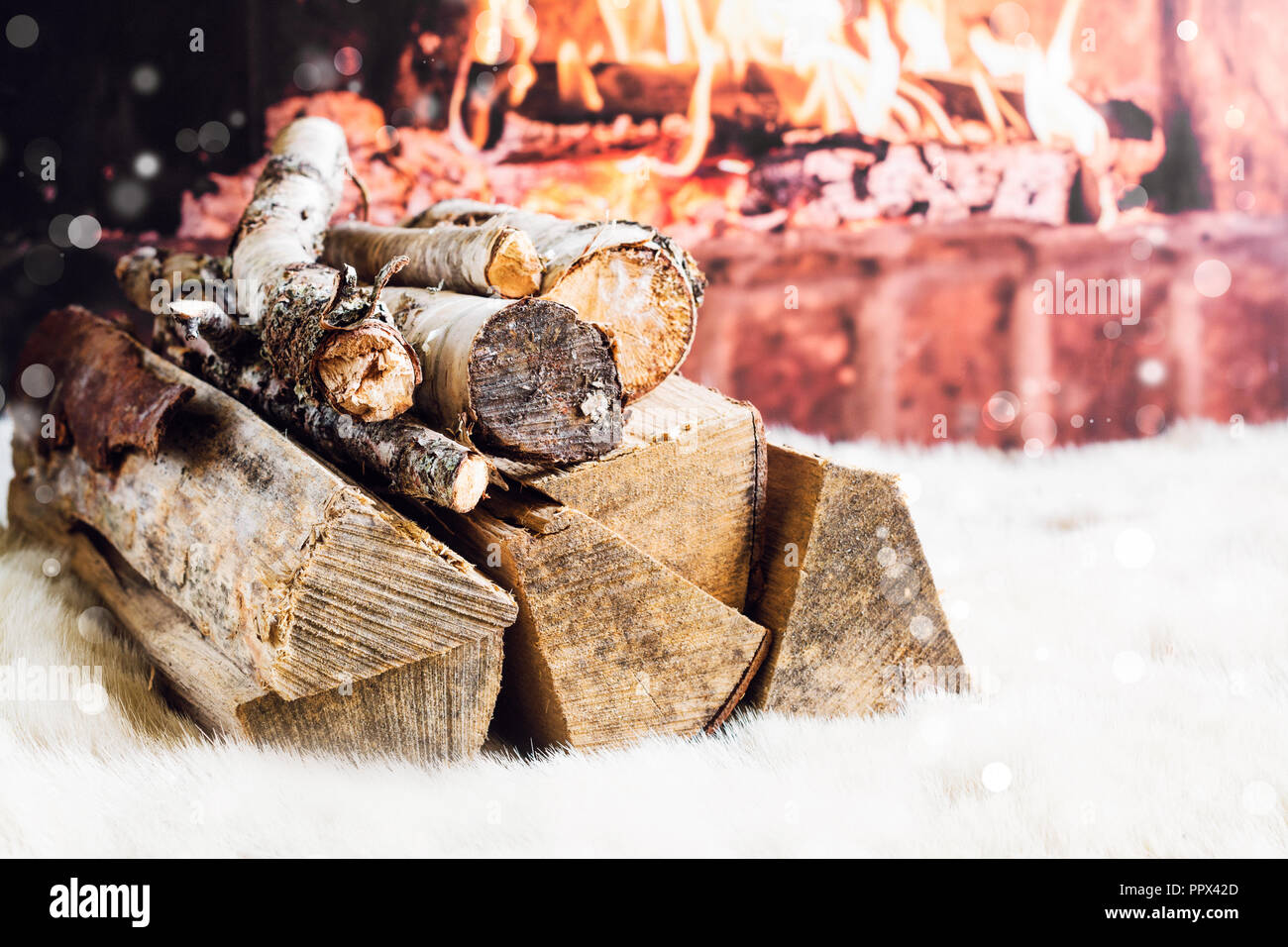 Pile of logs near fireplace Stock Photo - Alamy