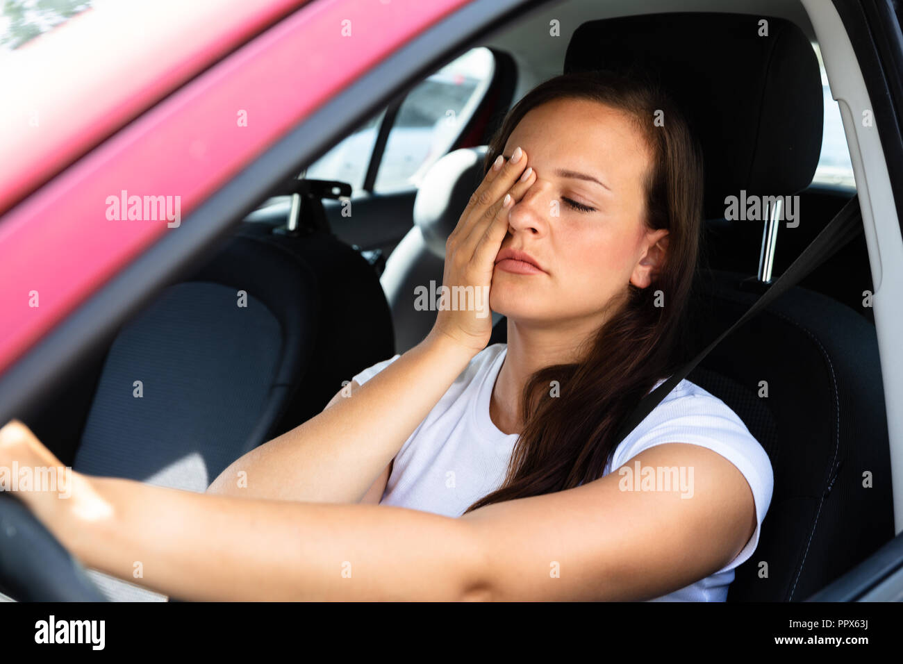 Side View Of A Young Woman Yawning Inside Car Stock Photo - Alamy