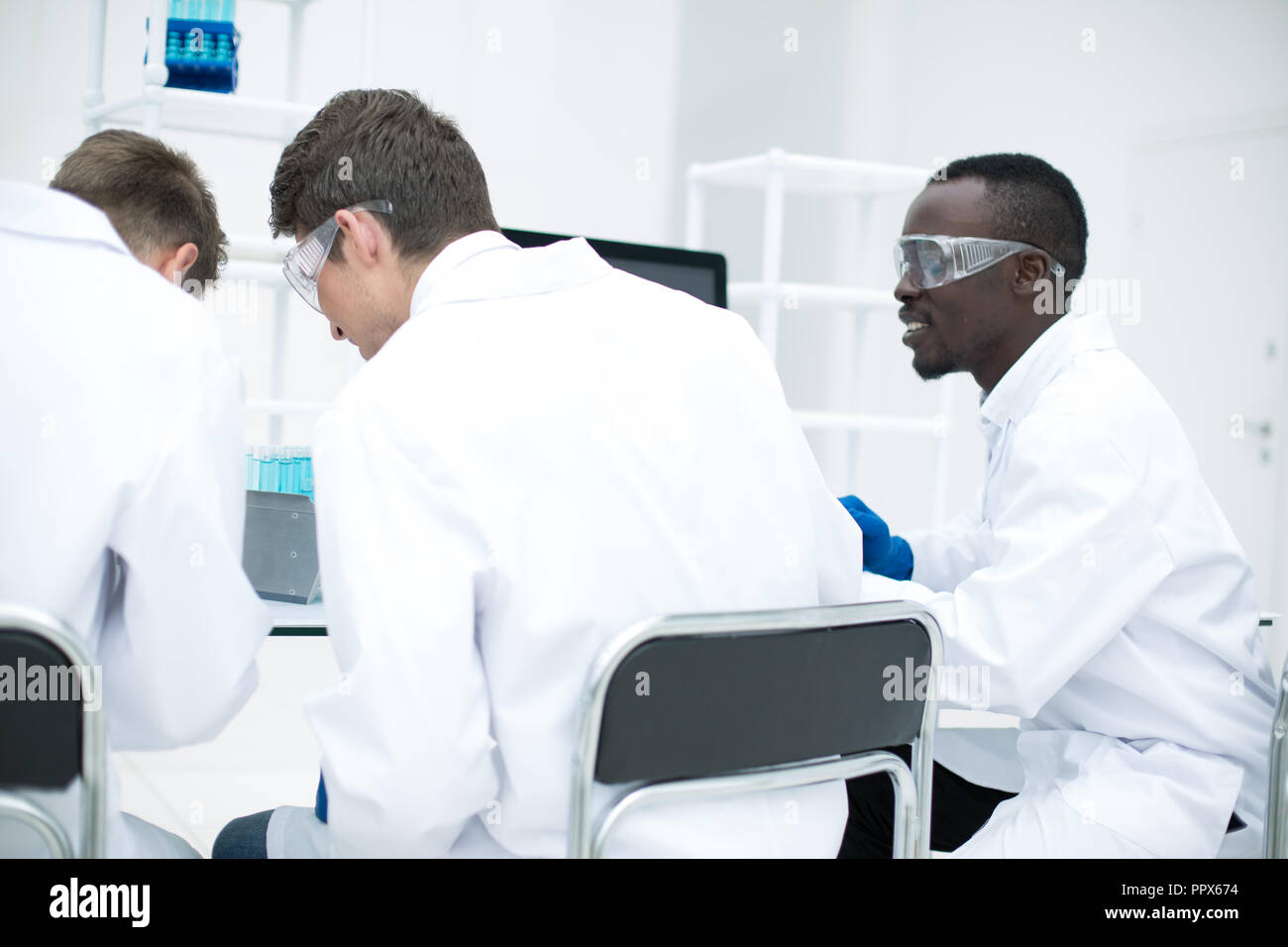 rear view. a group of scientists at the laboratory table Stock Photo ...
