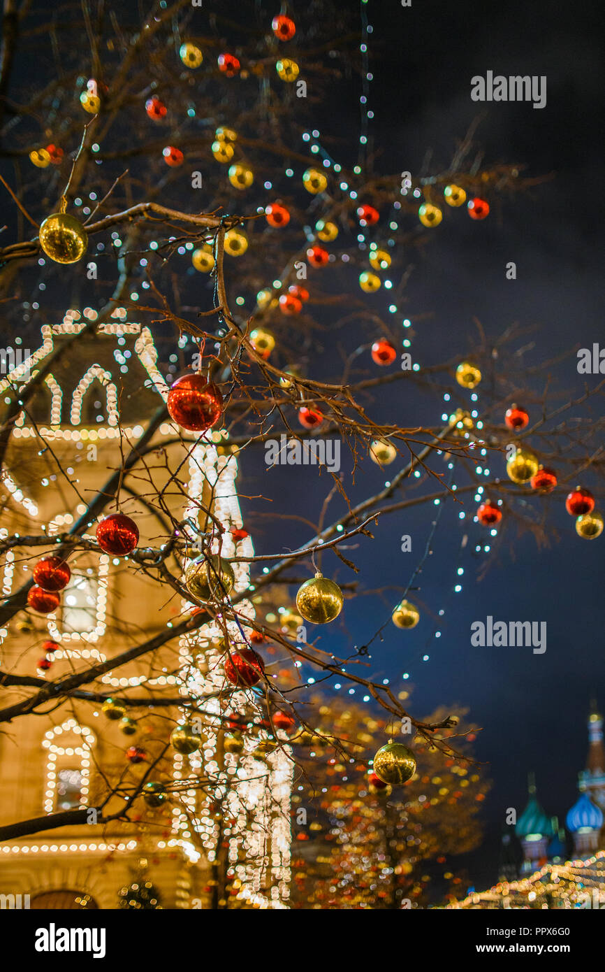 Photo of tree with golden and red balls on background of building Stock ...