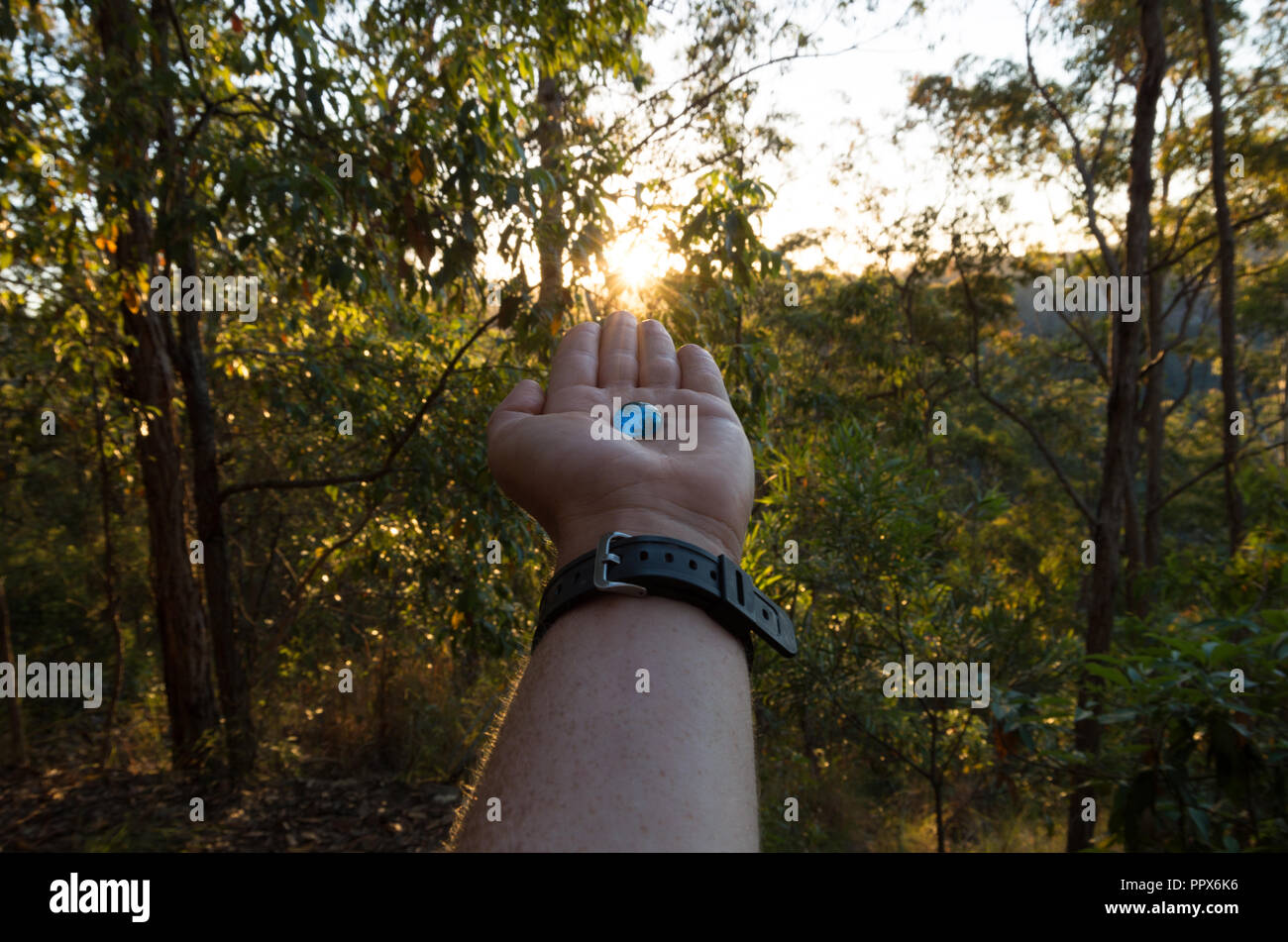 Blue Pebble in Sunlight being held in a hand Stock Photo - Alamy