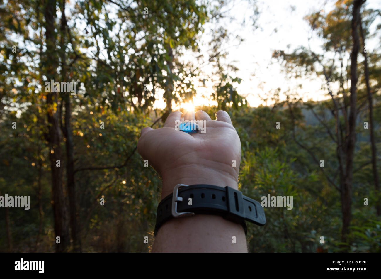 Blue Pebble in Sunlight being held in a hand Stock Photo - Alamy